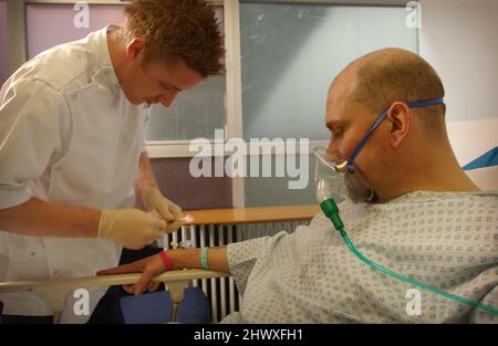 MODEL RELEASED. Intravenous drip. Patient connected to an intravenous ...