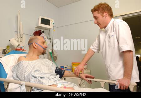 A male heart attack sufferer lays in his bed with a supply of oxygen ...