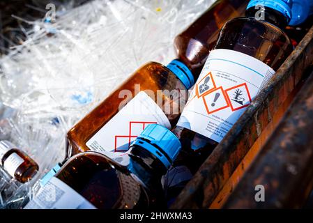 Glass bottles containing waste chemicals, waste management concept ...