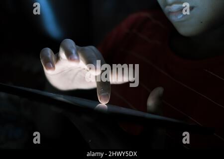 Finger touching tablet with dark background with copyspace Stock Photo ...