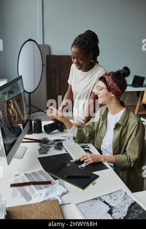 Photographer With Female Client Editing Images From Portrait Photo ...