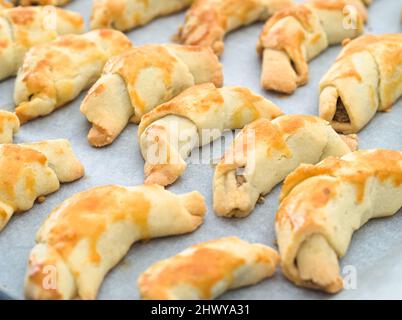 A baking tray filled with many cookie cutters and various other baking ...