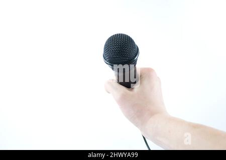 microphone on stage hand hold Stock Photo - Alamy