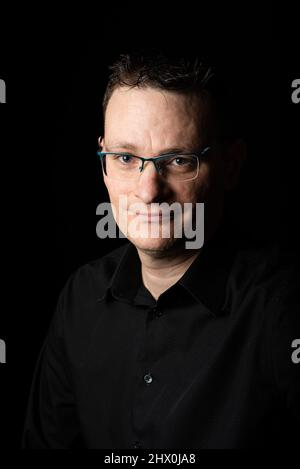 Portrait of a 42 year old business man, wearing a black shirt, Brussels ...