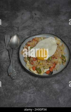 Nasi Goreng/Fried Rice served with fried egg Stock Photo - Alamy