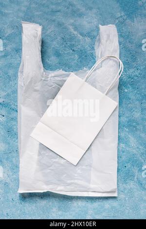 single use plastic bag next to paper one, plastic pollution and ...