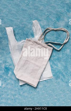 single use plastic bag next to reusable canvas one, plastic pollution ...
