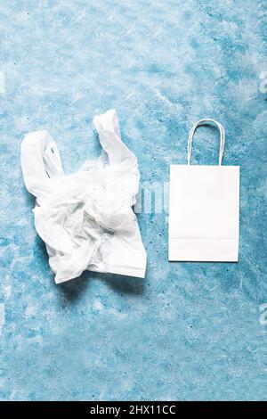 single use plastic bag next to paper one, plastic pollution and ...