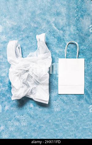 single use plastic bag next to paper one, plastic pollution and ...