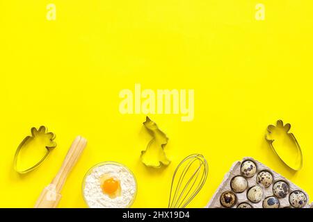 Composition with flour, cookie cutters, eggs and rolling pin on dark ...