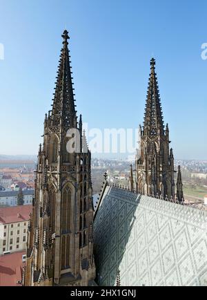 St. Vitus Cathedral with its Gothic spires and entrance gate surrounded ...
