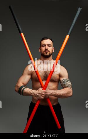 athlete men with stick training karate using sports tool in studio on ...