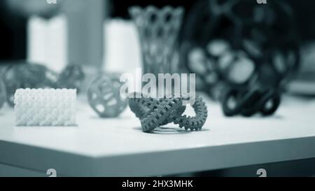Many abstract models bright colorful objects printed on a 3d printer ...