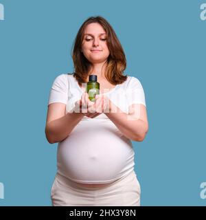 Body oil for pregnant woman, studio shot on white background Stock ...