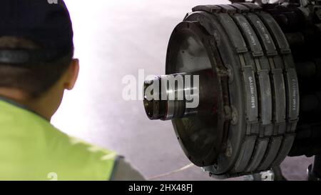 Airport worker checking chassis. Engine and chassis of the passenger ...