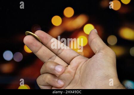 Holding a Brazilian money coin at a blurry lights background Stock ...
