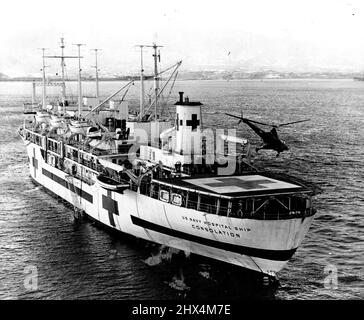 USS Consolation (AH-15) hospital ship. Nurse is taking a patient's ...