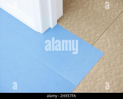 Laying a vinyl tile floor, tiling the edge, using craft knife and ruler ...