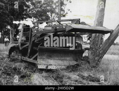 Treedozer blade pushes tree over with top blade; simultaneously the ...