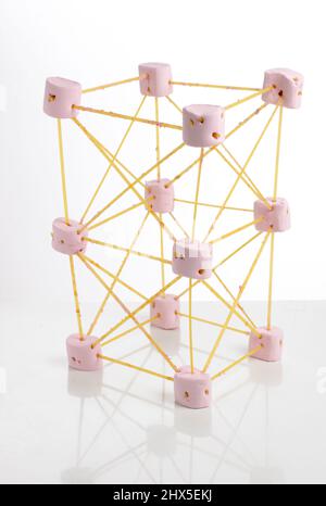 Vertical shot of a white geometrical structure on a white background ...