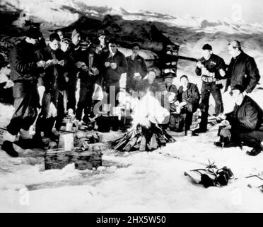 Coast Guardsmen dine on German canned goods at the site of an abandoned ...