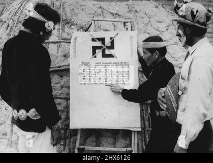 Four Native American baskets are displayed against a cloth backdrop ...