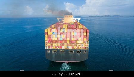 Stern of large cargo ship with Smoke exhaust gas emissions from cargo ...