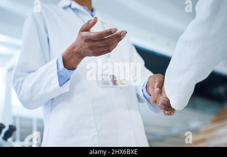 scientists shaking hands in laboratory Stock Photo - Alamy