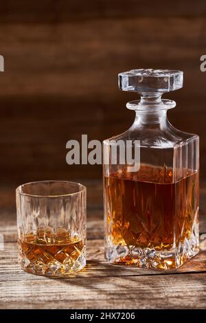 Bourbon or scotch in a classy decanter and a beautiful glass on a ...