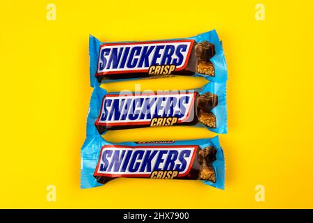 snickers crisp on a yellow background Stock Photo - Alamy