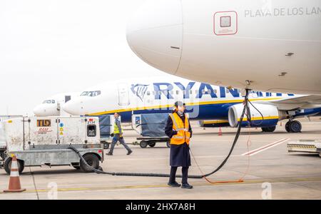 A worker employee refueling Iberia airlines Airbus A320 twin-engine jet ...