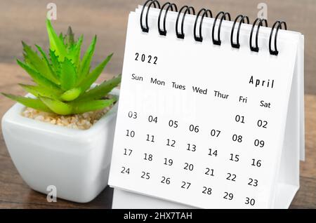 The April 2022 desk calendar with plant on wooden table Stock Photo - Alamy