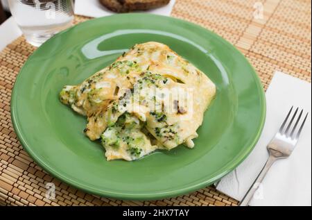 wholesome breakfast. omelet with broccoli on green plate Stock Photo ...