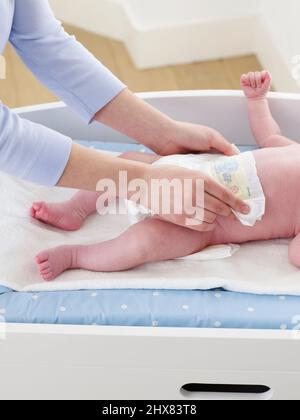 mother hands changing baby nappy Stock Photo - Alamy