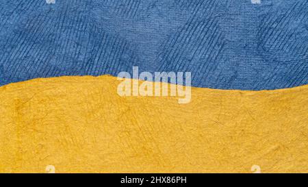 wavy paper abstract in colors of Ukrainian national flag - blue and ...