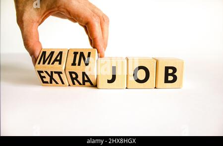 Extra or main job symbol. Businessman turns wooden cubes and changes ...