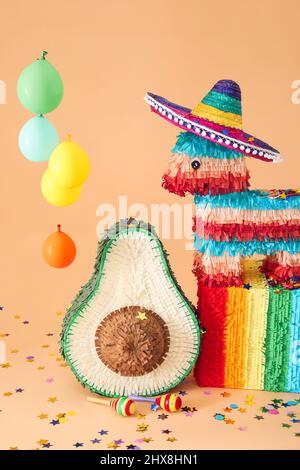 Different Mexican pinatas and balloons on beige background. Viva Mexico ...