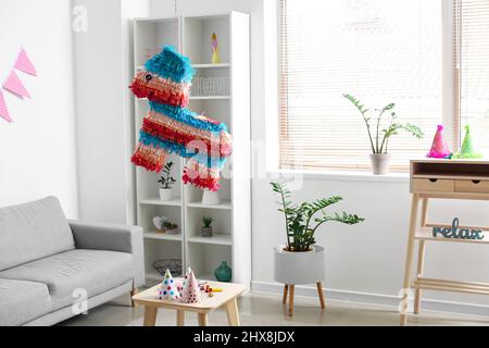 Mexican pinata hanging in living room decorated for Birthday party ...