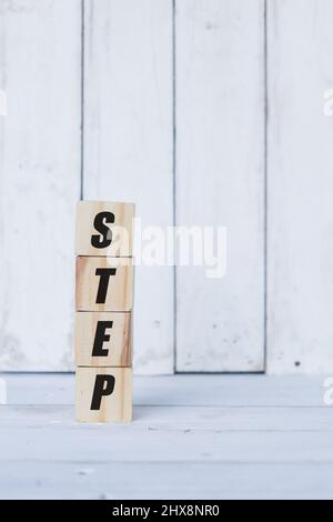Step symbol. Concept word Step on wooden cubes. Beautiful orange ...