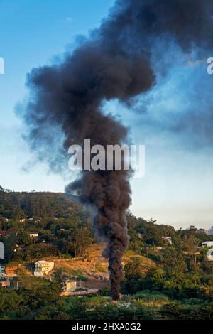 A huge black column of smoke in abandoned ground Stock Photo - Alamy