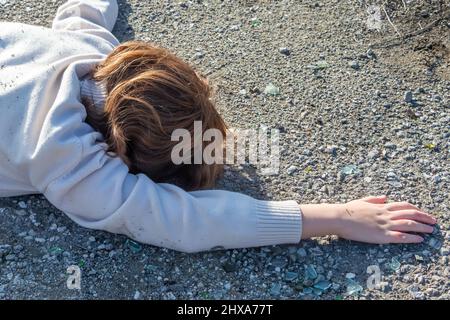 a teenage girl lies dead on the road, the murdered corpse of a girl's ...