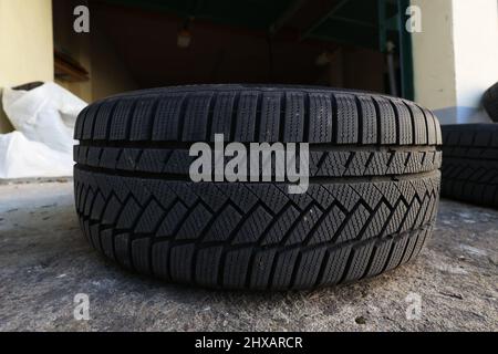 Set of new winter and summer tires on asphalt road, collage . Banner ...