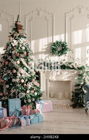 New Year's gifts in designer paper and bright ribbons under the ...