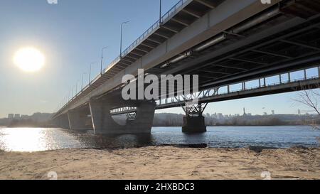 The Sun set over New Darnytskyi Bridge in Kyiv, Ukraine, during the ...