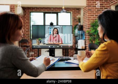 Women meeting with applicant on video call at online job interview ...