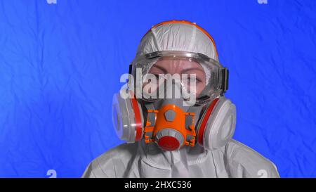 Scientist virologist in respirator. Slow motion. Man close up look ...