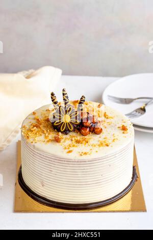 Celebratory cake with white chocolate croquant on a white background ...