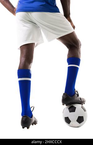 A soccer player stepping on a ball with arms crossed Stock Photo - Alamy