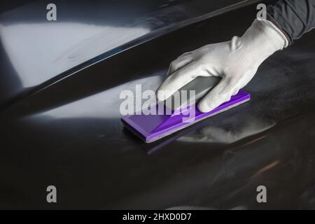 Grinding car body parts with a manual sanding planer before painting ...