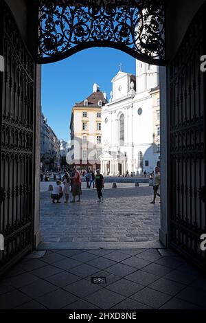 Michaelerkirche, St. Michaels church on Michaelerplatz square on bright ...